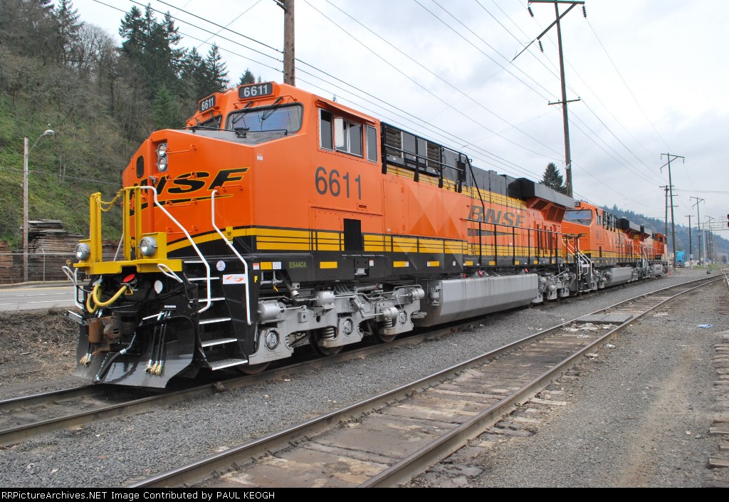 BNSF 6611 with BNSF 6613 and 6612 and HWY 30 west behind them.
